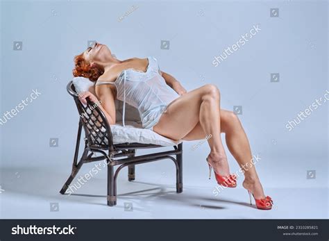 Middle Aged Sexy Woman Lingerie Sitting On Armchair White Studio Background Images Stock
