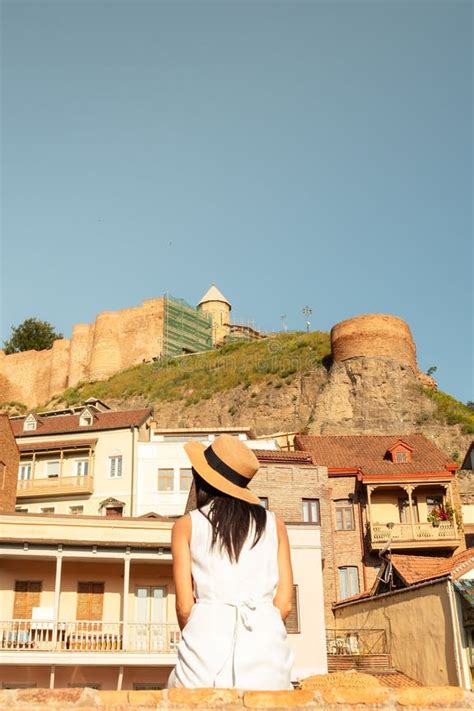 Female Traveler Overlooks Tbilisi Old Town Architecture With Narikala