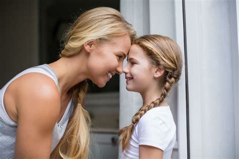 Affectionate Mother And Daughter Sharing A Joyful Moment Indoors