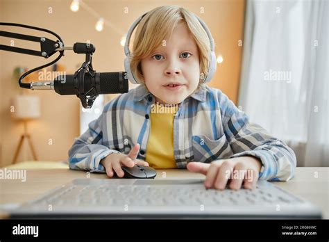 Cute Schoolboy Clicking Mouse And Pressing Buttons Of Laptop Keyboard