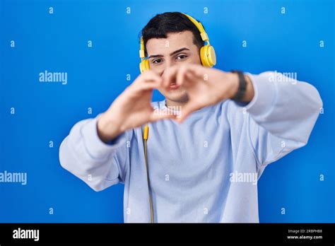 Non Binary Person Listening To Music Using Headphones Smiling In Love