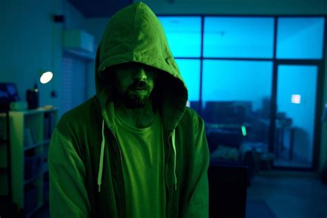 premium photo man hacking or dark hoodie in neon living room with