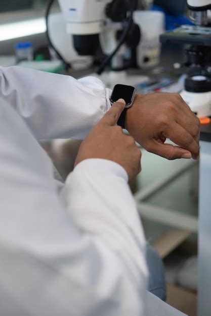premium photo closeup of a scientist using a smartwatch in the lab