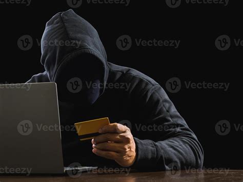 Portrait Hacker Spy Man One Person In Black Hoodie Sitting On Table Looking Computer Laptop Used
