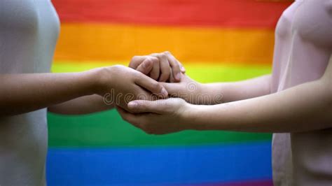 Two Lesbians Holding Hands And Kissing While Lying On Bed In Morning
