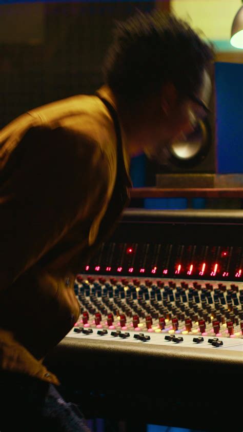 Vertical African American Sound Designer Operates Control Desk Mixer