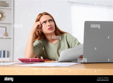 Woman Doing Taxes At Table In Room Stock Photo Alamy