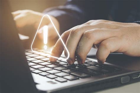Businessman Using Laptop Computer With Alerts Warning Triangles
