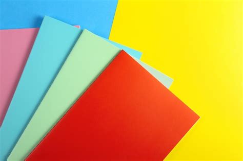 Premium Photo Multi Colored Notebooks On Colored Background