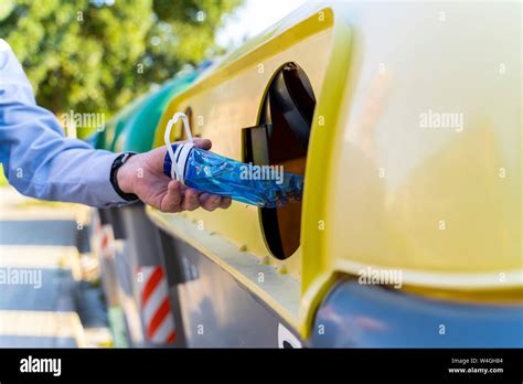 Close Up Of Man Putting Plastic Bottle Into Recycling Bin Stock Photo Alamy