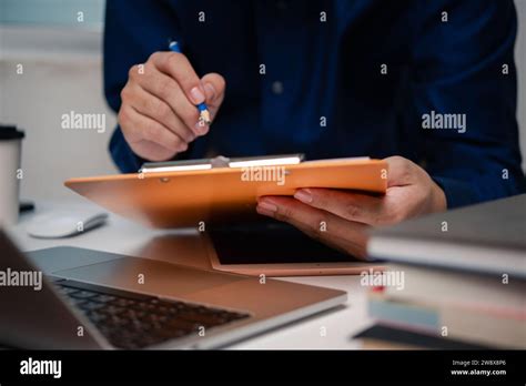 Man Holding Clipboard With Checklist Employee Workplace Is Reviewing