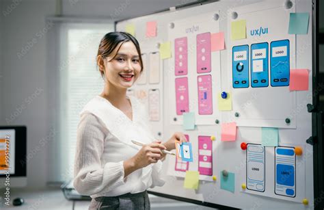 Babe Asian Woman Happily Works As A Ux Ui Designer Smiling While Using Sticky Notes To Plan A