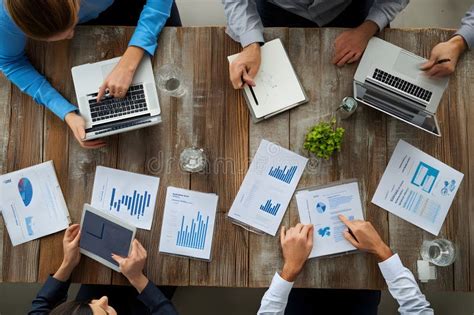 Business Collaboration With Laptops Charts And Financial Reports On Wooden Table Stock