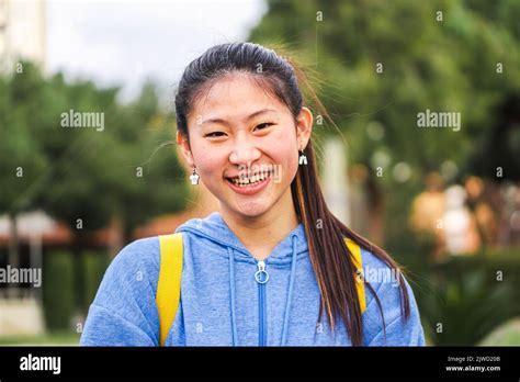 Young Chinese Lady Student Smiling Looking At Camera At The High School