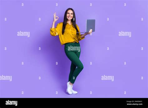 Full Size Portrait Of Cheerful Attractive Girl Hold Netbook Show Okey