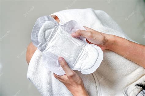 Premium Photo Woman Wearing A Towel Holding A Sanitary Napkin Or