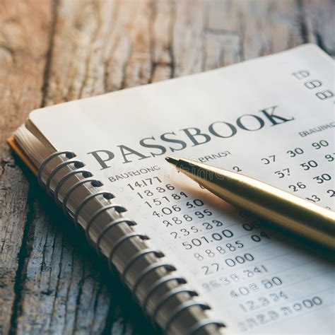 Accurate Record Keeping And Financial Management Depicted With Passbook Pen And Wood Surface