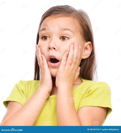 La Fille Mignonne Tient Son Visage Dans Létonnement Photo Stock
