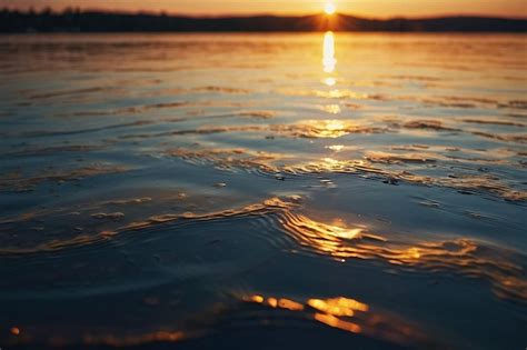 Premium Photo Sunset Reflecting On Glassy Lake Surface