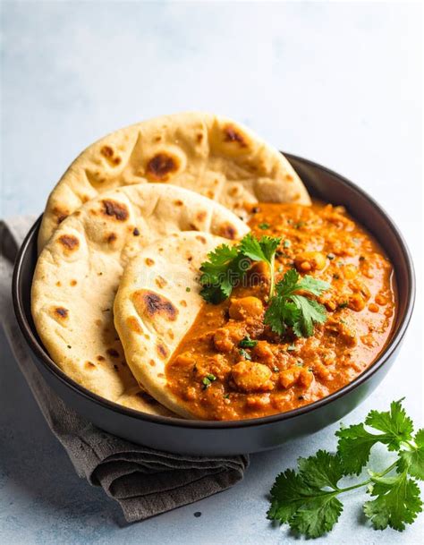 A Bowl Of Mauritian Farata Flatbread Served With Bean Curry Garnished