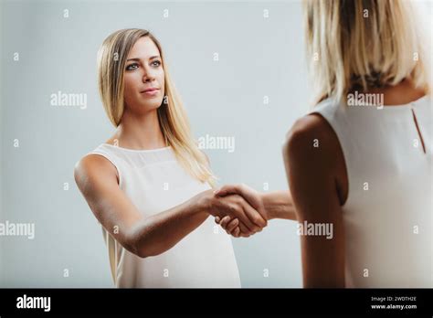 Strong Eye Contact And A Firm Handshake Communicate The Blonde Womans