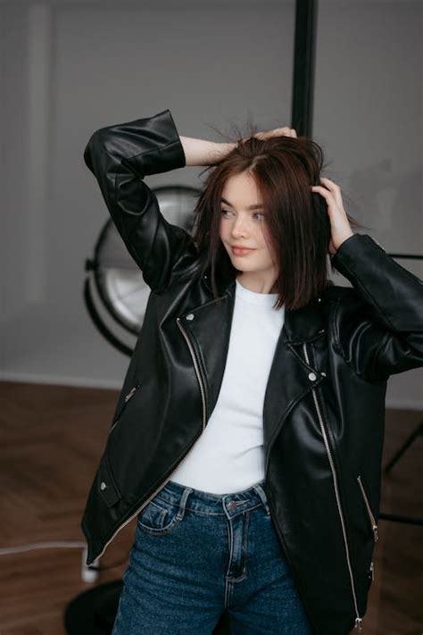 Pretty Young Woman In Leather Jacket Posing With Hands In Hair · Free
