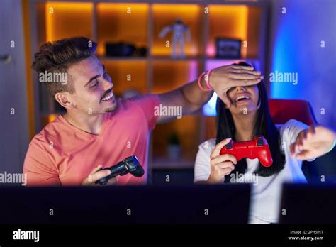 Man And Woman Streamers Playing Video Game Using Computer And Joystick Cheating At Gaming Room