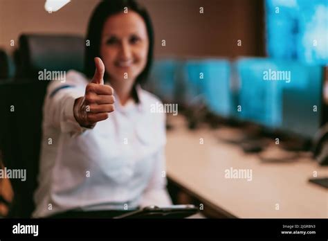 Portrait Of Female Security Operator While Working In A Data System Control Room Offices