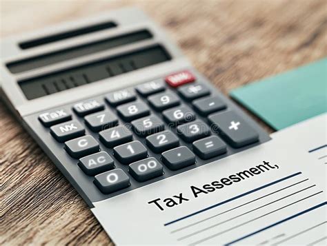Income Tax Assessment Calculator And Tax Assessment Form On A Wooden