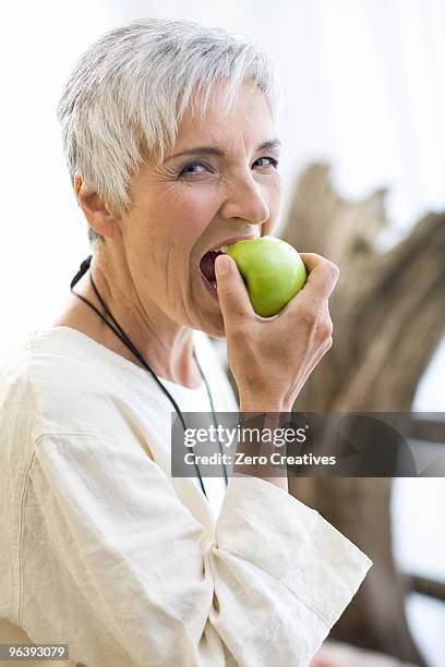 Mature Woman Eating Healthy Snack Photos And Premium High Res Pictures