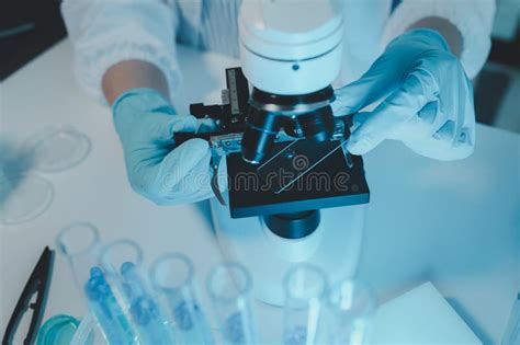 Chemist Is Doing An Experiment In The Laboratory A Scientist Is Using A Microscope To Analyze