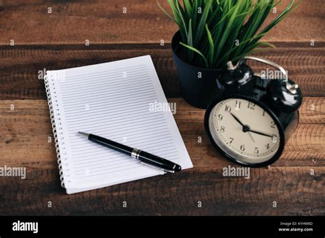 Clock Pen And Blank Notebook On Wooden Table Background Stock Photo Alamy