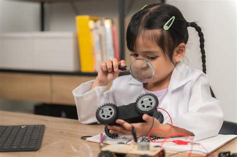 Premium Photo Asian Littlle Girl Constructing And Coding Robot At