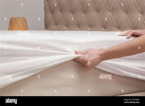 Changing Bed Sheets Woman Is Putting On A Fitted White Cotton Sheet On A Mattress While Making
