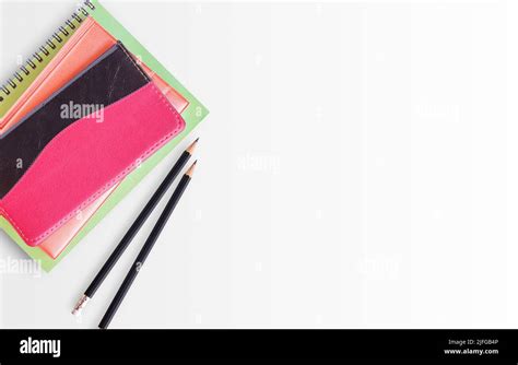 Notebook And Pencil On Office Desk Or White Talbe Background Top View