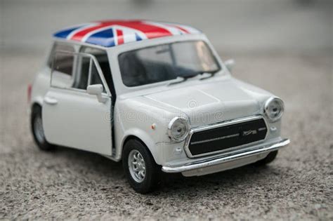 Closeup Of Old White Mini Cooper With British Flag On Roof On Stoned