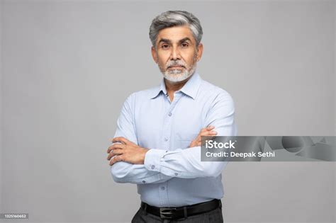 Portrait Of Mature Business Men Standing Isolated Over Gray Background