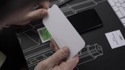 Close Up Of Male Hand Preparing And Installing Screen Protector On