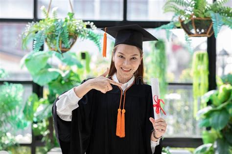 Beautiful Attractive Asian Woman Reading Book To Learn For Education Holding Certificated Stock