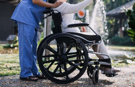 Asian Young Caregiver Nurse Support Senior Older Male Walking Outdoors Specialist Girl Doctor