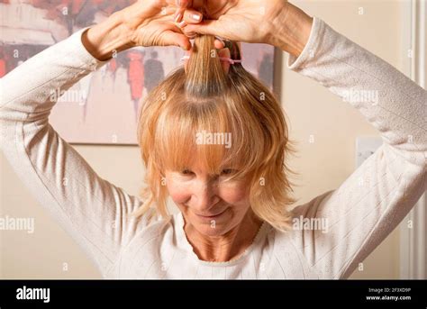 Woman Putting Her Hair In Curlers Stock Photo Alamy