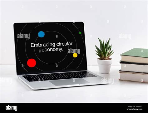 Laptop Displaying Circular Economy Concept With Orbiting Planets Promoting Resource Efficiency