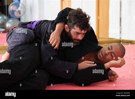 Two men practicing Brazilian Jiu-Jitsu sparring at the Academy Stock Photo - Alamy