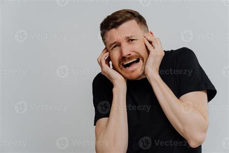 Scared Man Screaming While Being Afraid And Looking With Frightened