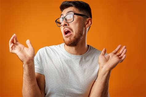 Premium Photo Portrait Of Young Nerd Man Shrugging Shoulders I Dont