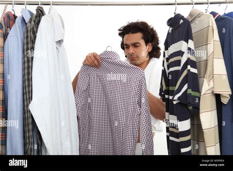 Man Choosing Shirt To Wear Stock Photo Alamy