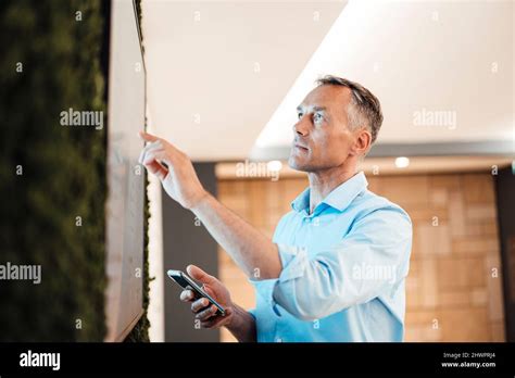 Businessman Pointing At Touch Screen Computer Monitor In Coworking