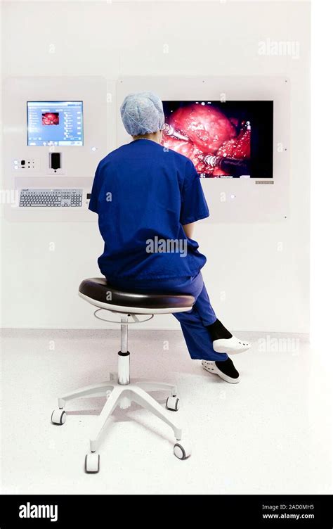 Robot Assisted Thyroidectomy Surgery Surgeon Watching A Display Of An Operation Being Carried