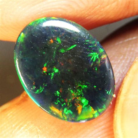 247ct Natural Color Play Ethiopian Black Opal Oval Shape Cabochon