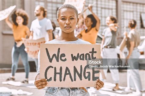 Black Woman Protest Group And Sign About Peace Justice And Gender